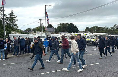 DUP MP defends photo with masked men at Scarva protest - National News ...